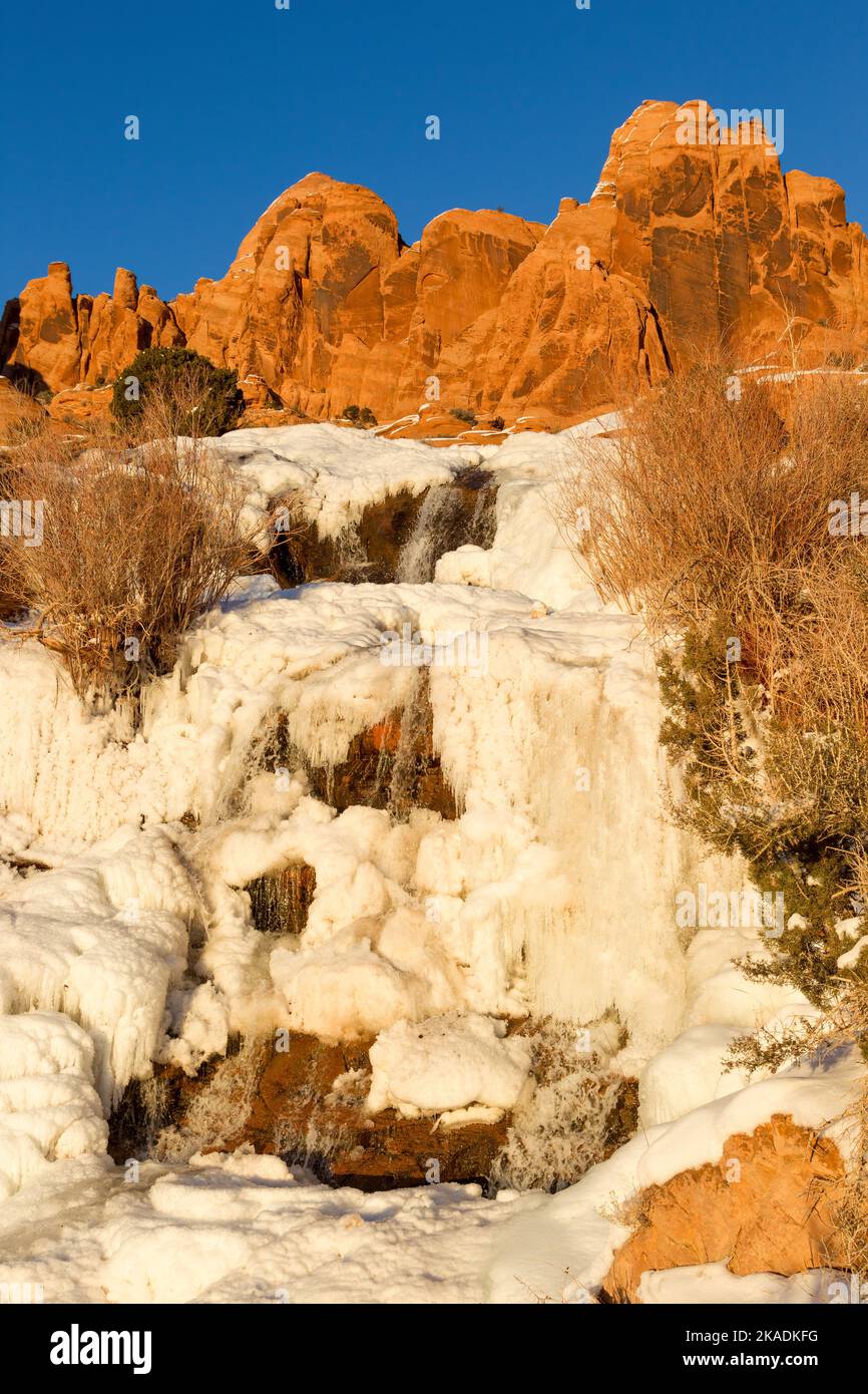 Sunset light on cascades on a small creek in the desert in winter near ...