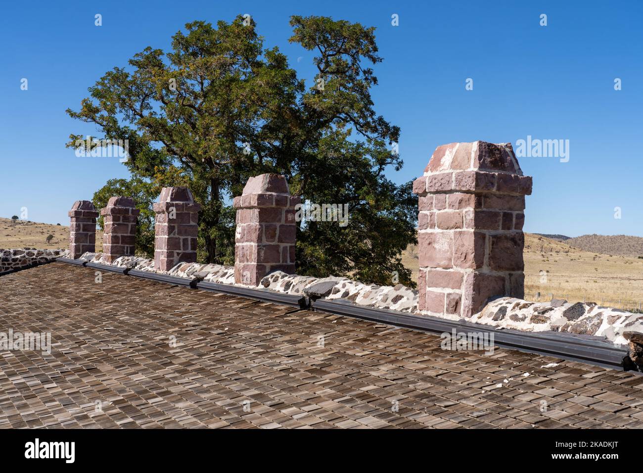 Limestone chimneys and cedar shake roof of the Cove Creek Ranch Fort ...