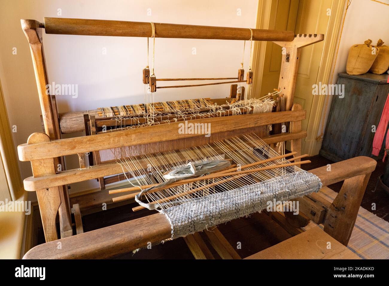 A wooden foot-treadle loom for making a rag rug at the Cove Creek Ranch ...