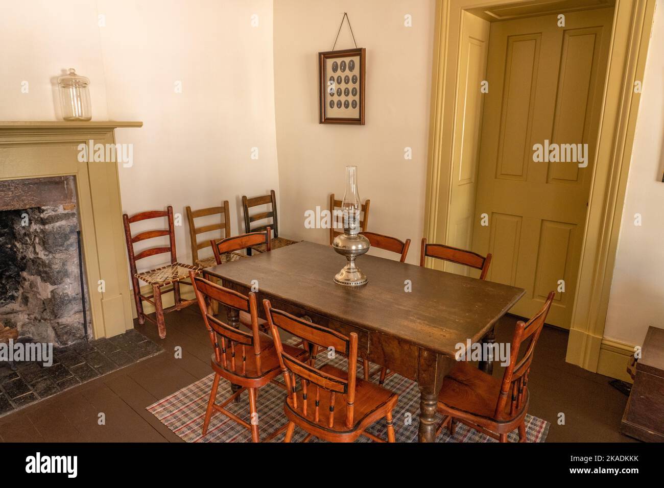 An antique table, chairs & kerosene lamp in a dining room in the Cove ...