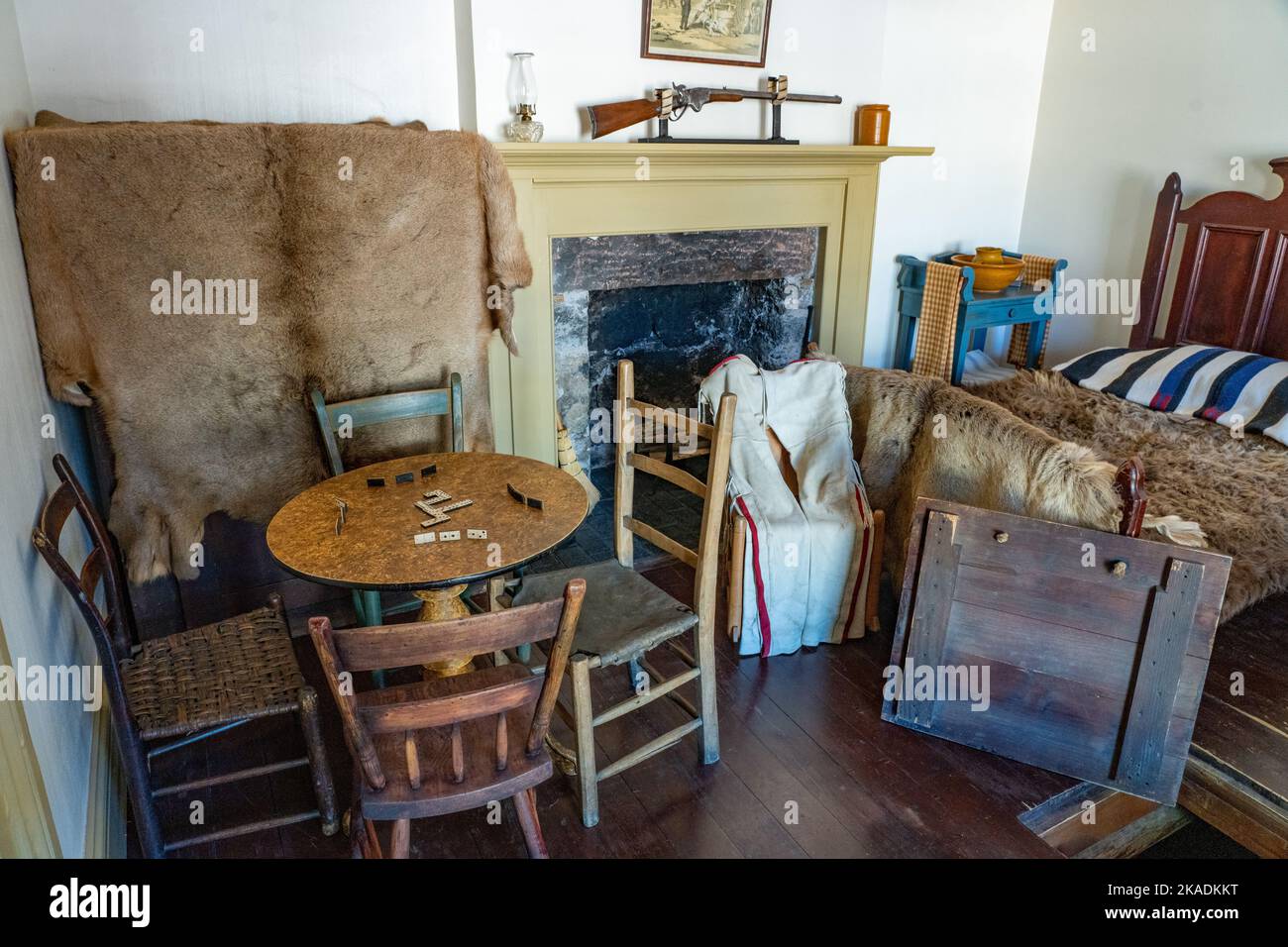 Dominos on a table & elk hides & a buffalo hide in a lodging room of ...