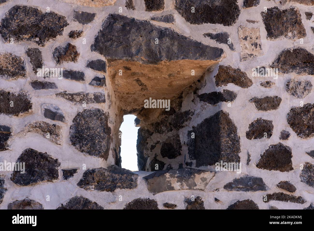 A gun port or shooting port in the stone wall of the Cove Creek Ranch ...