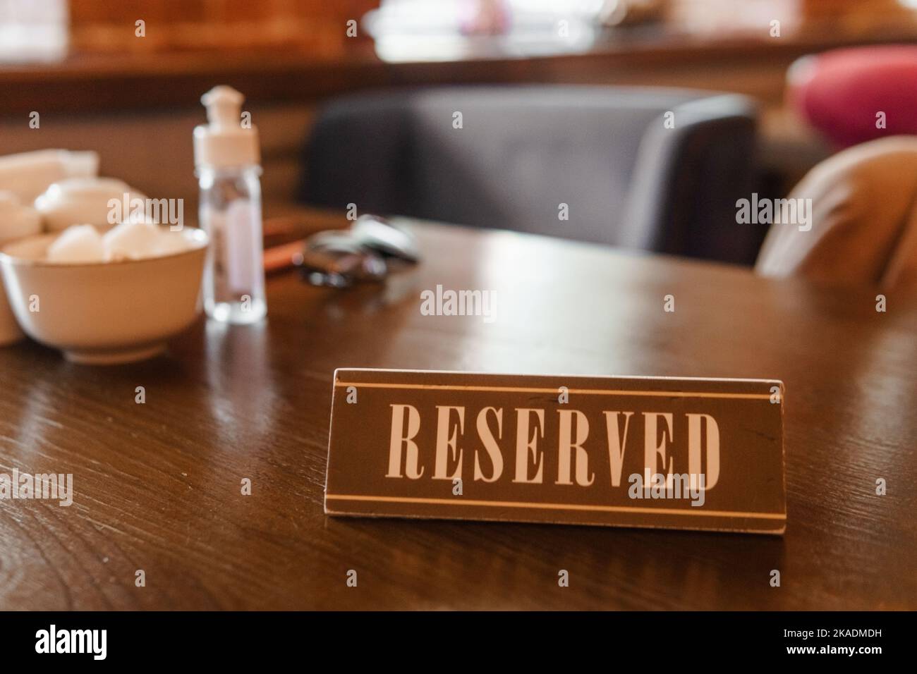 A sign with the inscription - reserved, standing on a wooden table in ...