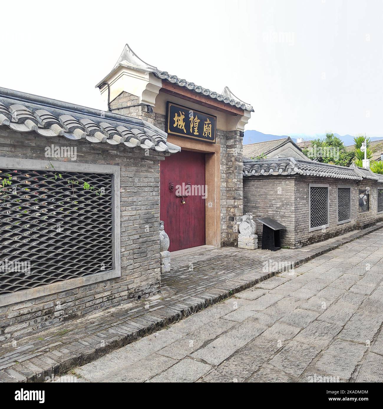 A closeup of the Dapeng Ancient City wall with a sign in the Chinese ...