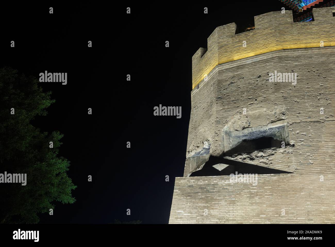 A part of a medieval fortress with half-destroyed windows illuminated ...