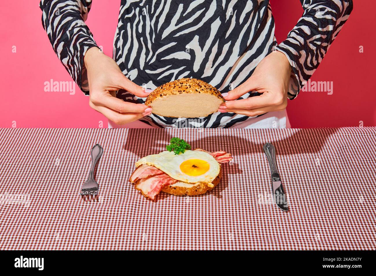 Woman making delicious american breakfast with bagel, fried eggs and ...