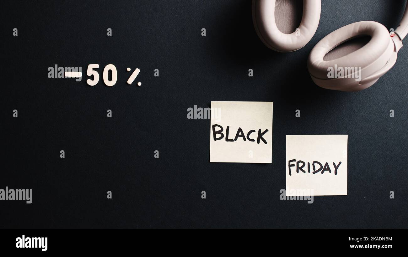 Yellow post-it note for black friday day. Black background with copy ...