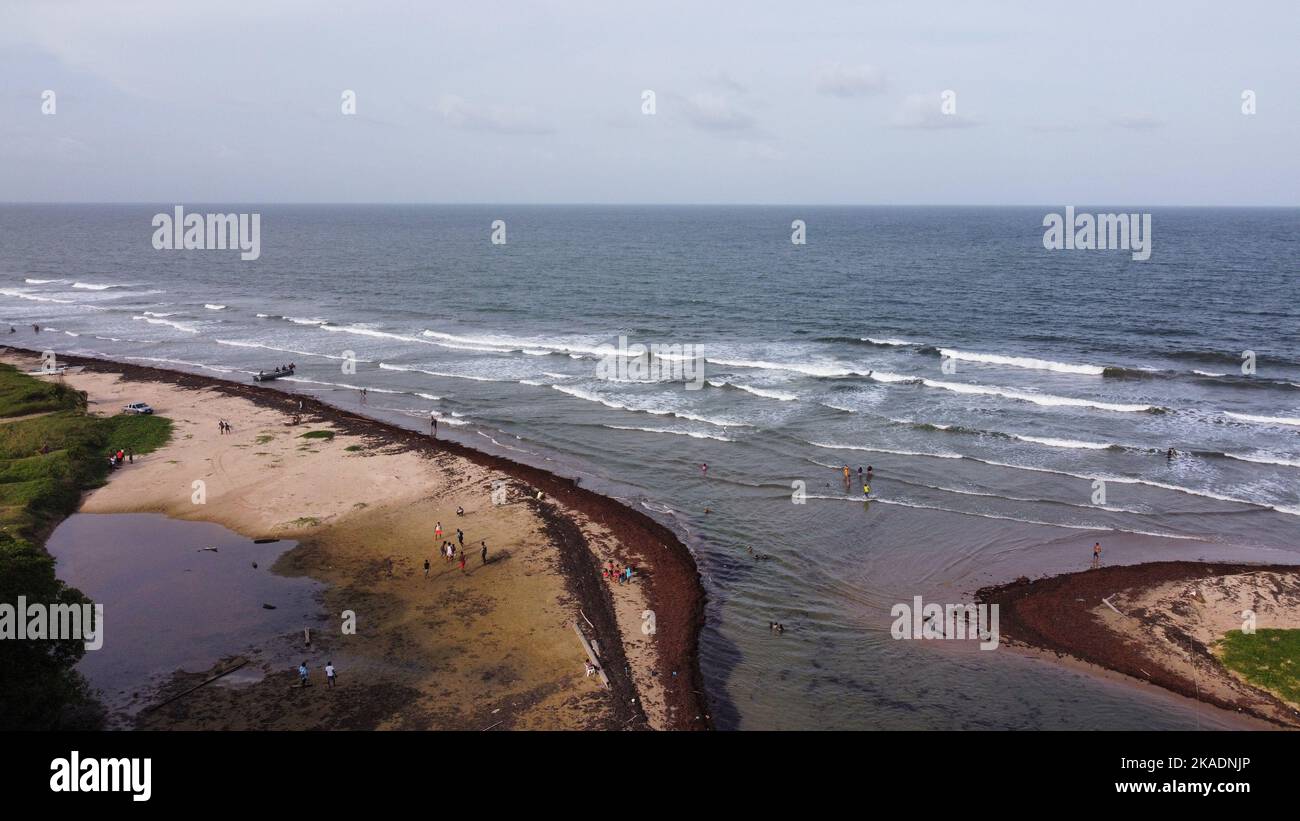 An aerial view of people having fun at the beautiful beach in Chaguanas ...