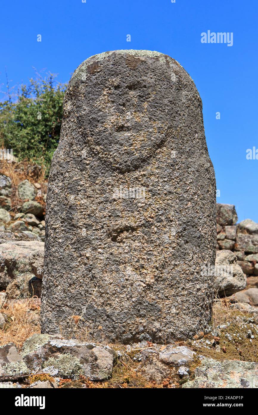 Close-up of a menhir with a carved human face at the megalithic site of ...