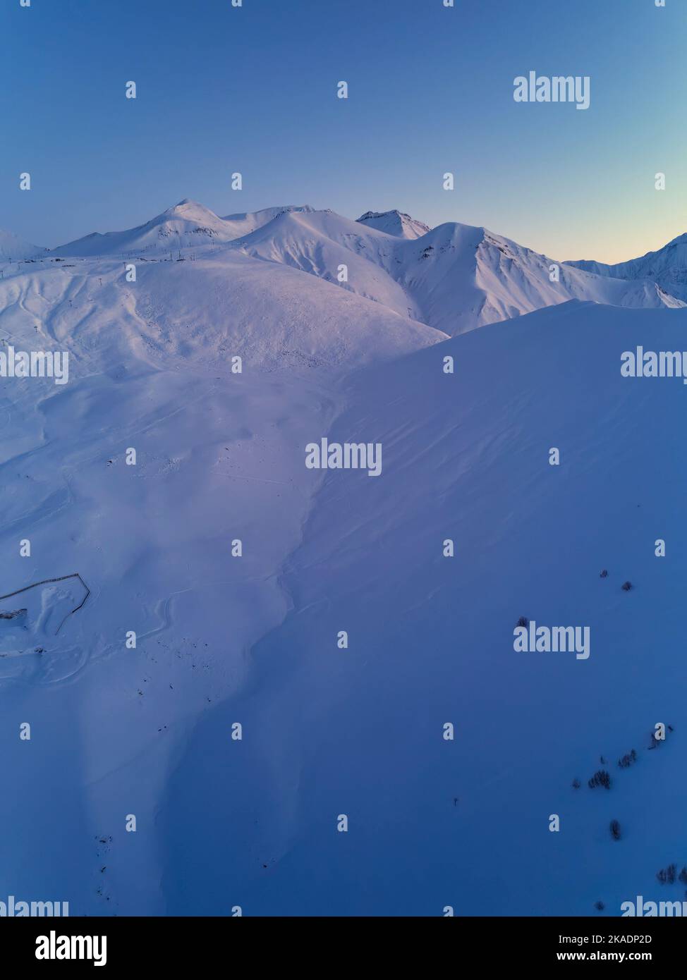 Aerial of snowy mountain slopes full of powder for freeride at ski ...