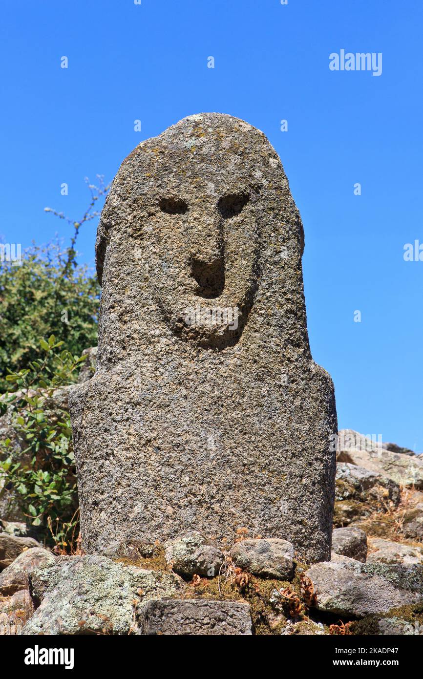 Close-up of a menhir with a carved human face at the megalithic site of ...