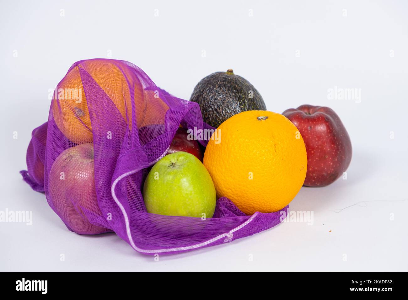 Fabric mesh for fruits and vegetables on a white background. A reusable ...