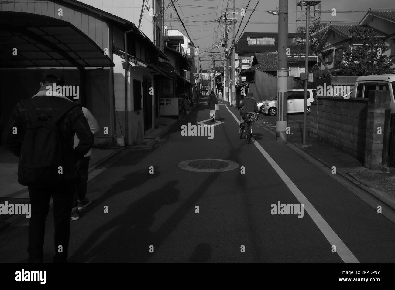 A beautiful shot of people walking on the street between houses in ...