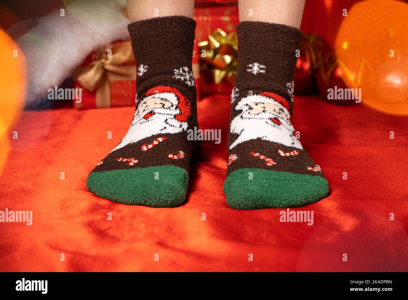 Women's feet in warm Christmas socks with Santa Claus close-up Stock ...