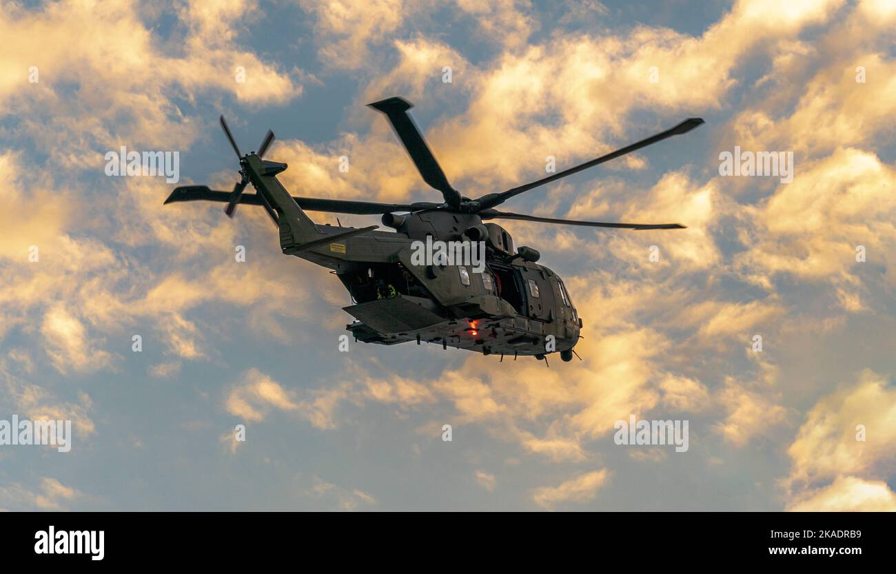A scenic view of a helicopter flying high in the cloudy sky background ...