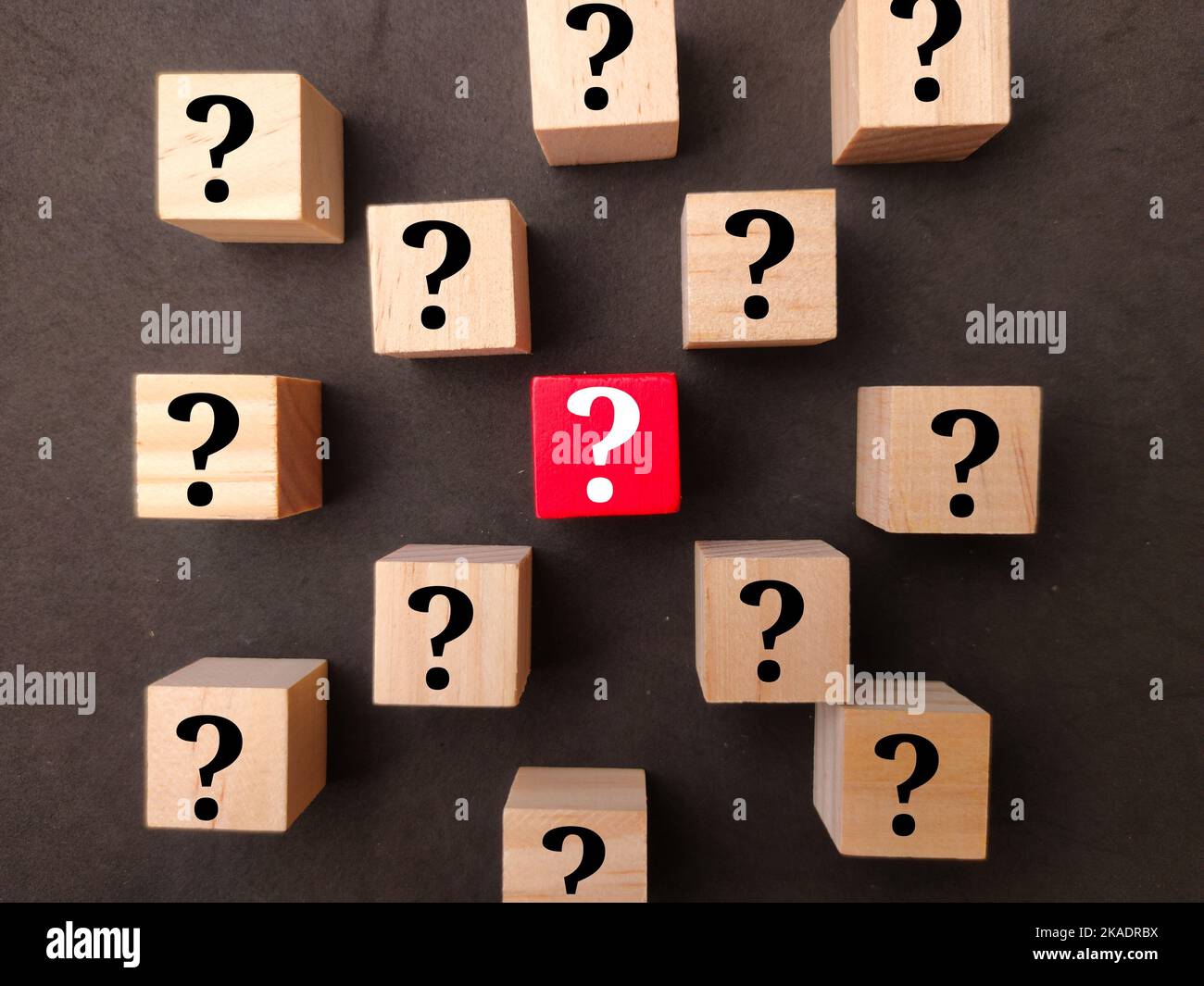 A top view of wooden cubes with question mark icons-concept of ...