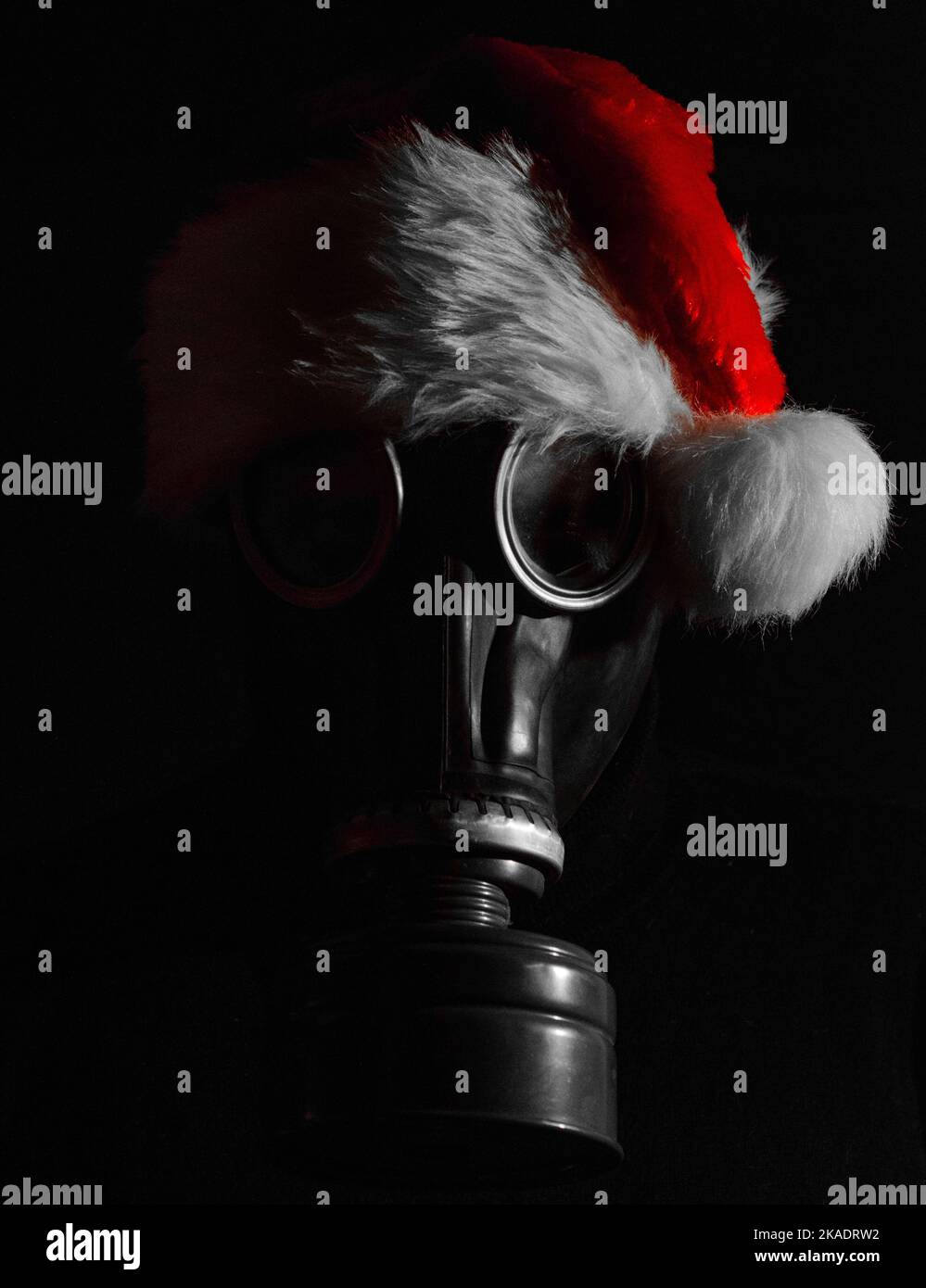 A vertical closeup of the gas mask with a red Santa's hat isolated on ...