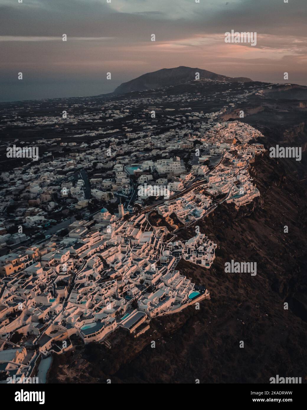 A beautiful vertical aerial view of the city of Thera in Santorini ...
