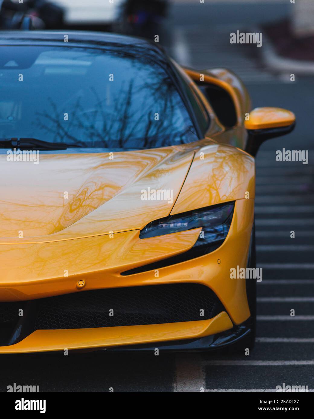 A front view of a luxurious yellow supercar parked outside Stock Photo ...
