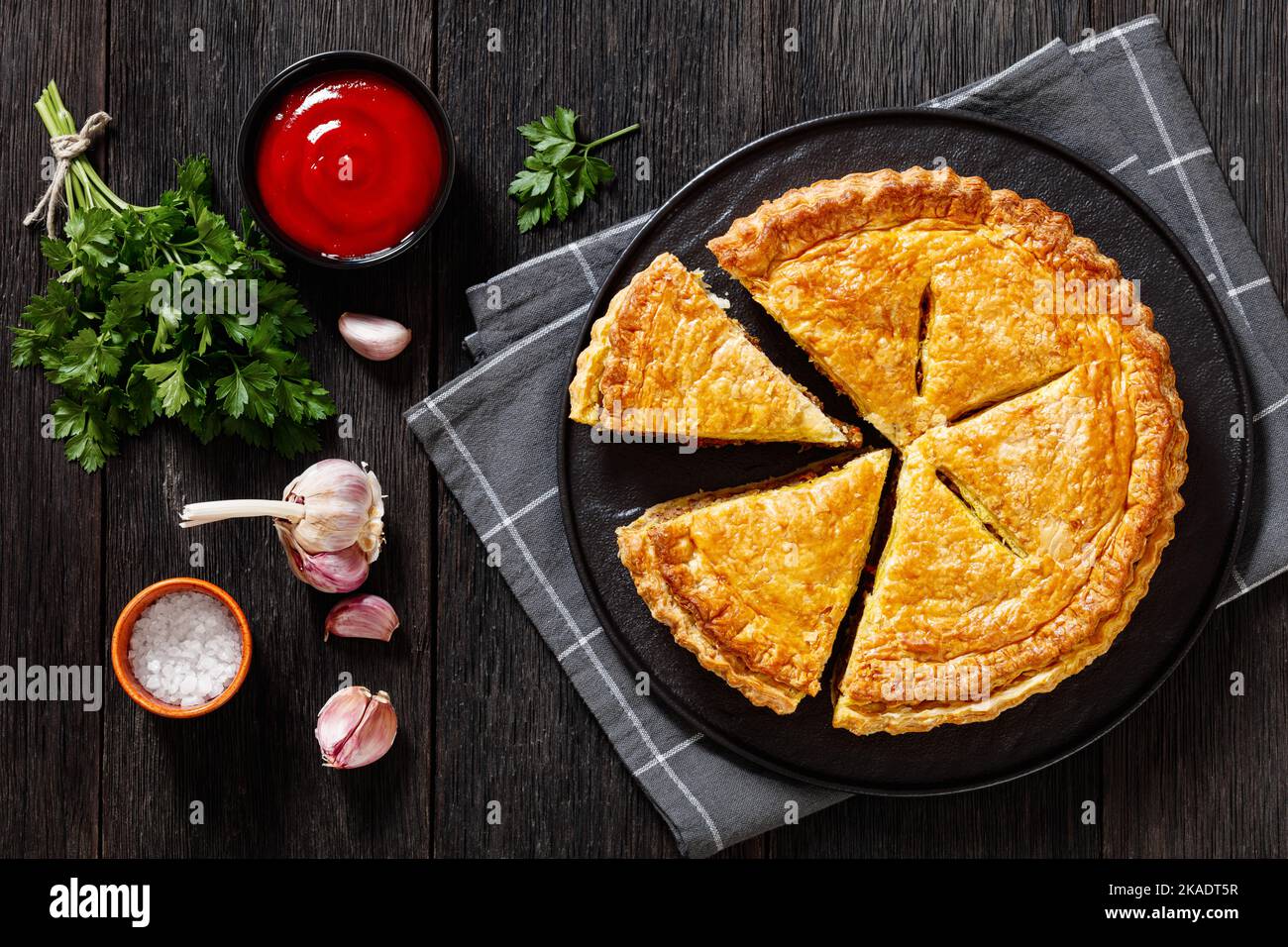 sliced Ground Beef Meat Pie with a flaky puff pastry double crust with ...
