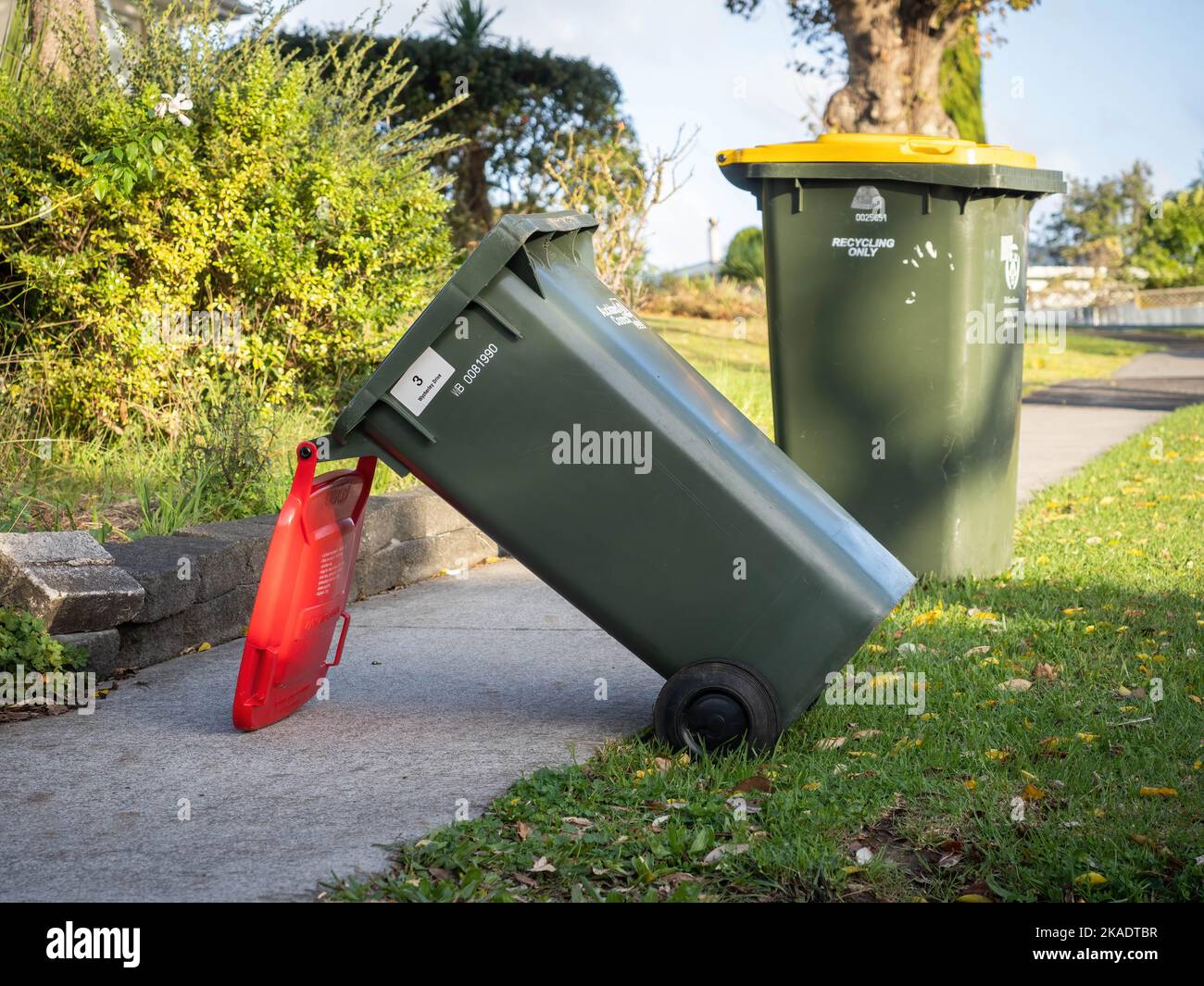 View of rubbish wheelie bins toppled by strong wind laying on ground ...