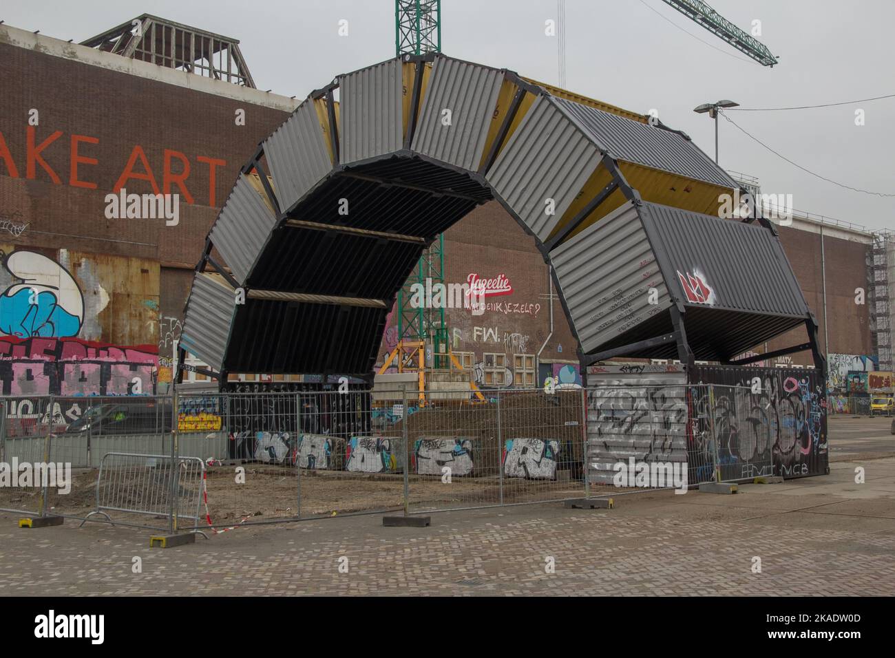 A view of a metallic arcade construction against buildings with ...