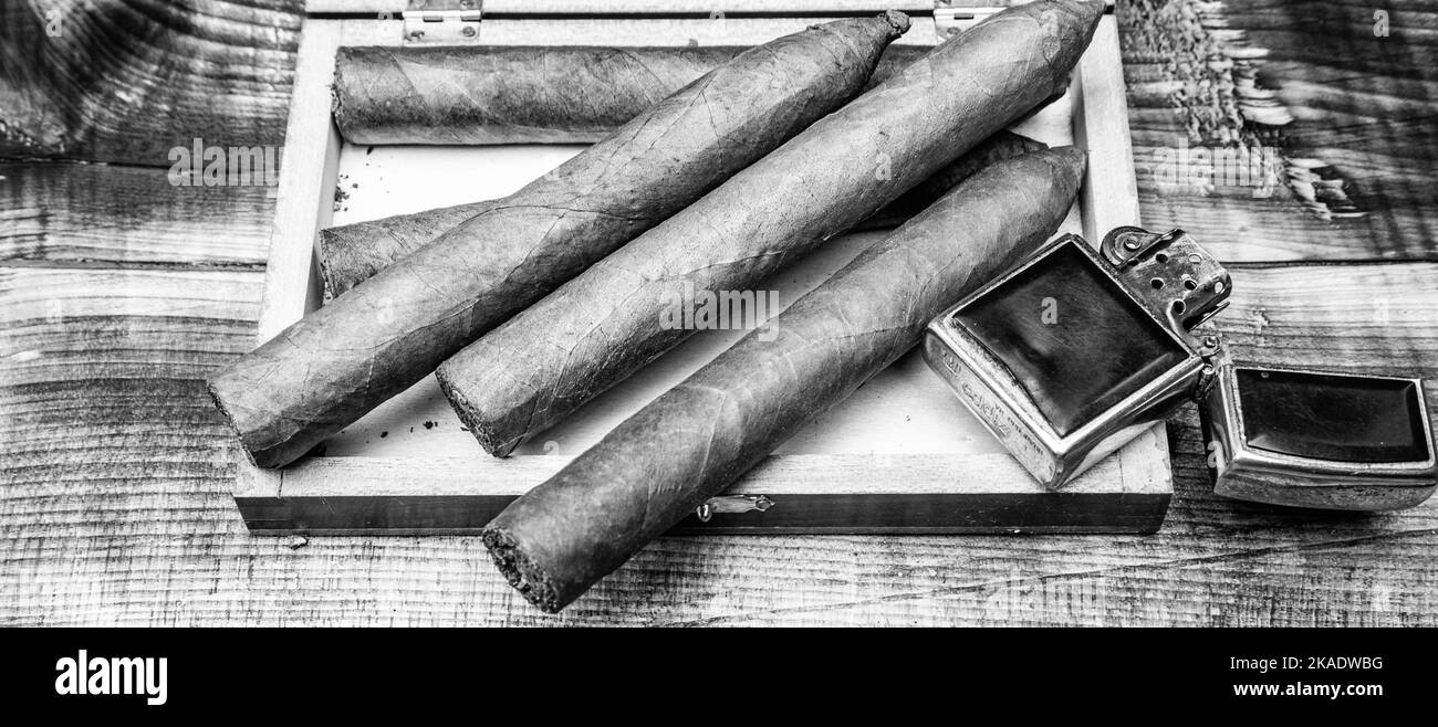 Cigars in box and vintage lighter. Cuban cigars wooden background ...