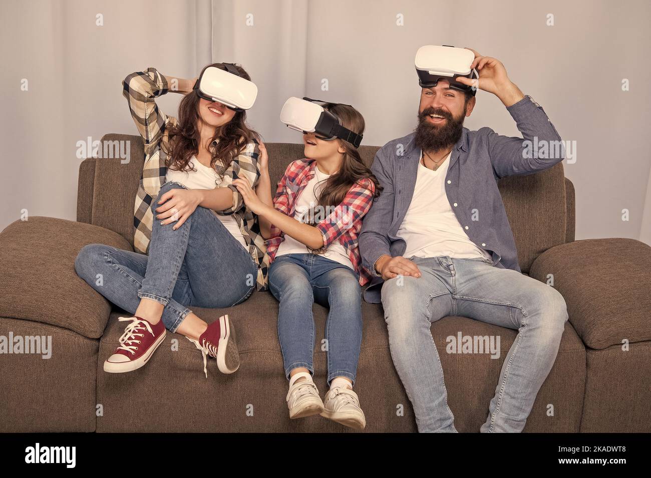 virtual reality family. happy parents with kid girl use modern ...