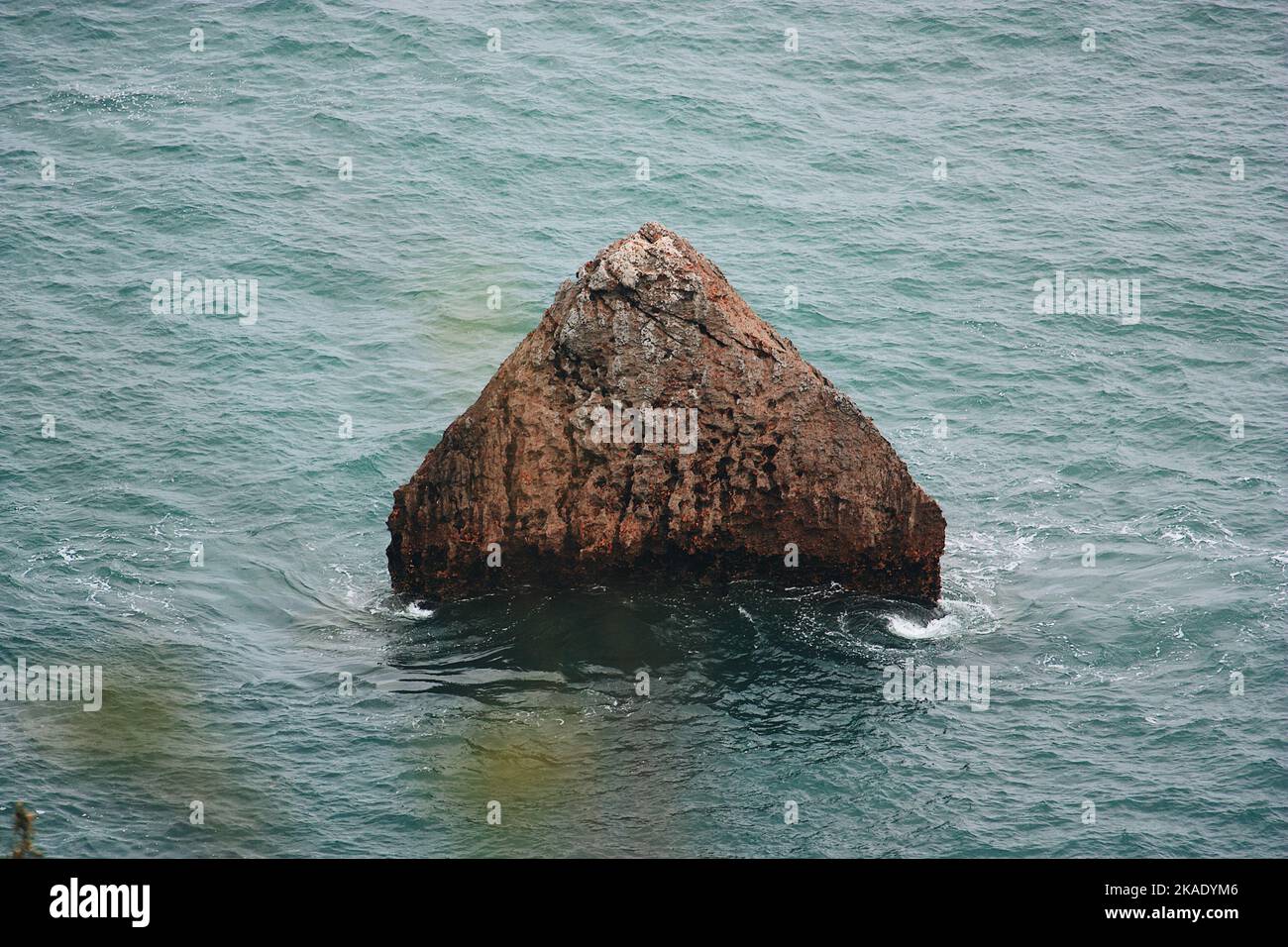 The pointed rock on the water surface Stock Photo - Alamy