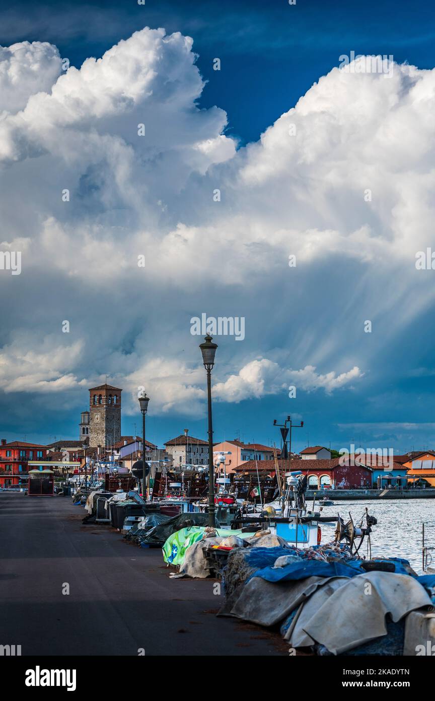 Towards the sunset. Marano lagoon late summer colors. Clouds and sun ...