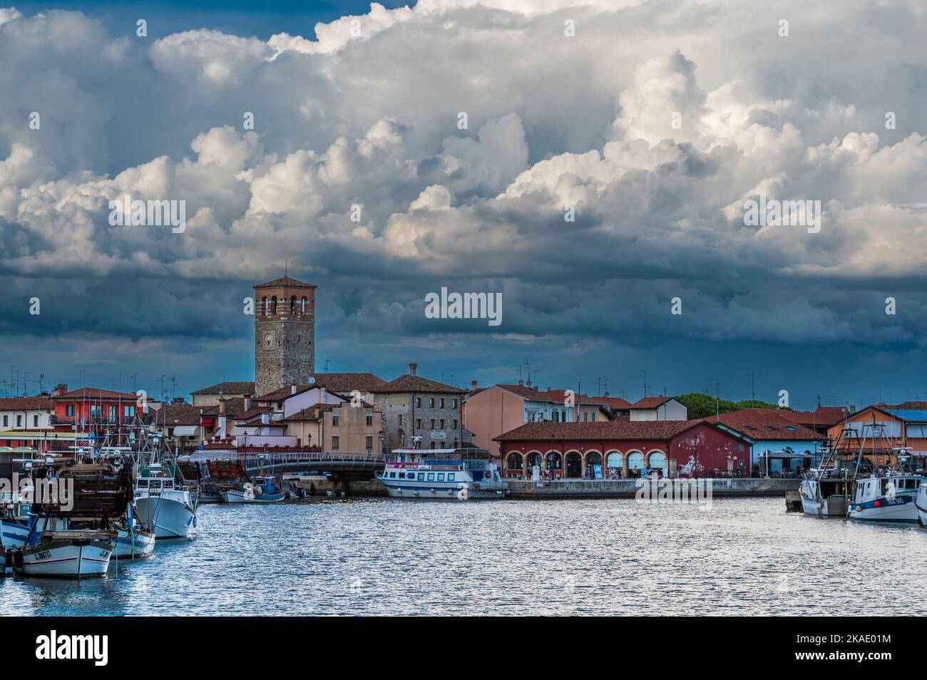 Towards the sunset. Marano lagoon late summer colors. Clouds and sun ...