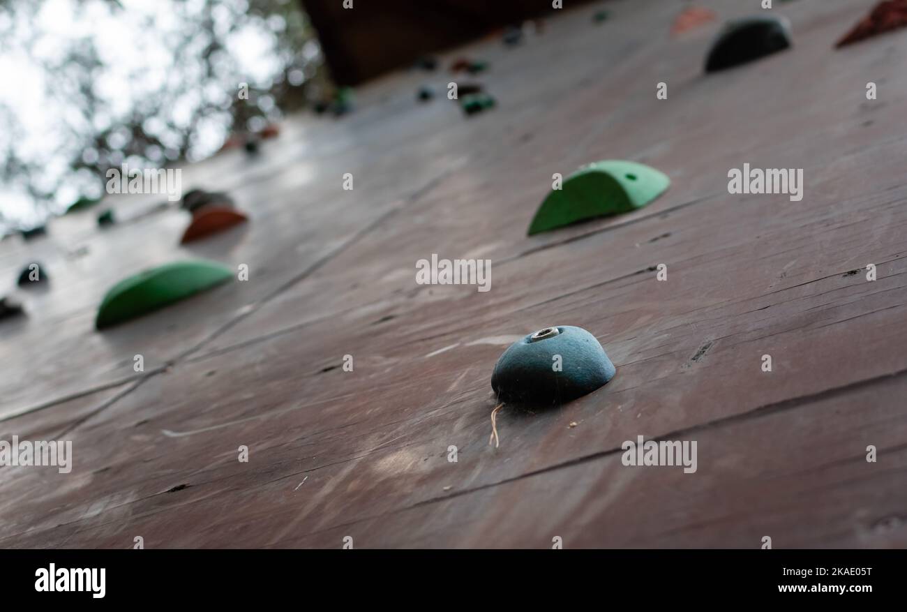 Wall ledge for rock climbing close-up on blurred surface background ...