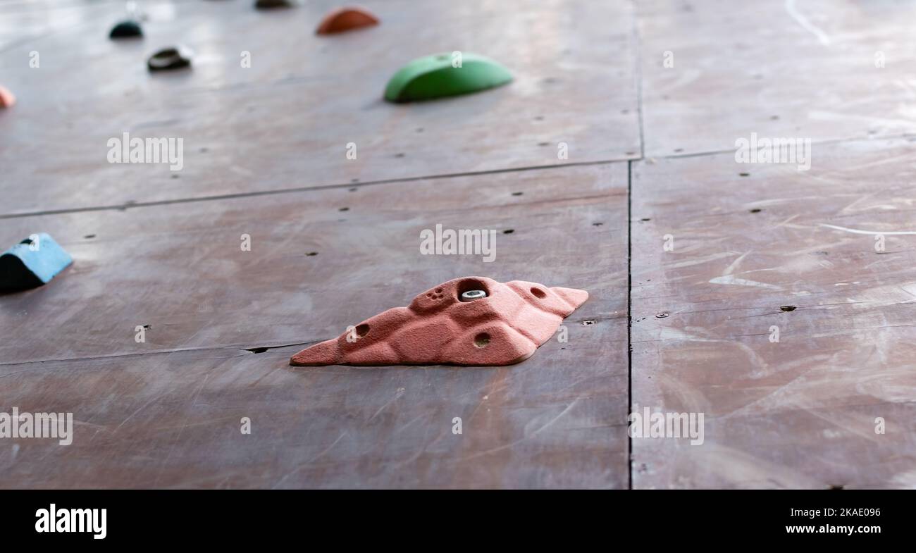 Wall ledge for rock climbing close-up on blurred surface background ...