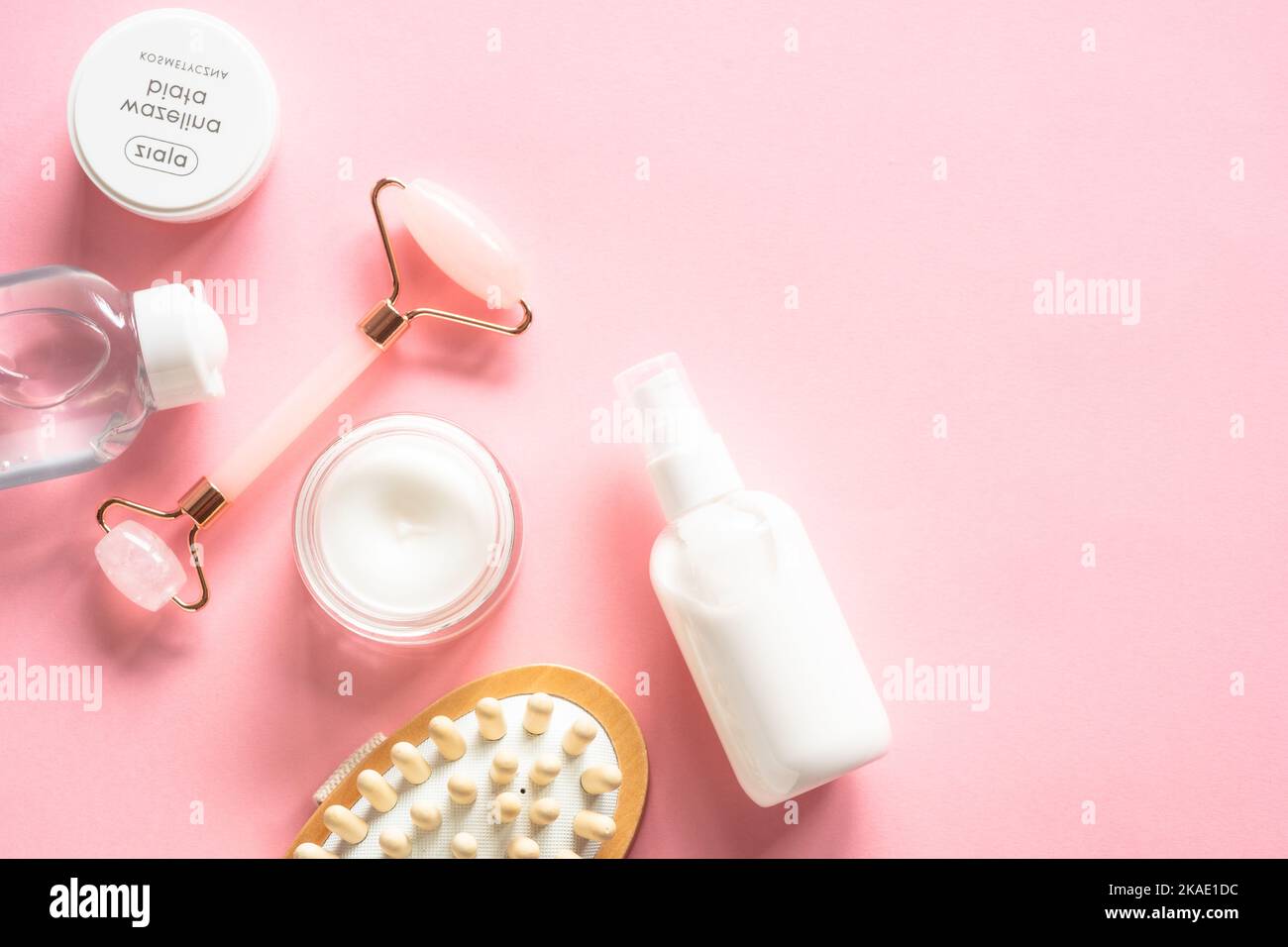 Natural cosmetics on pink. Skin care product, cream, soap serum, jade ...