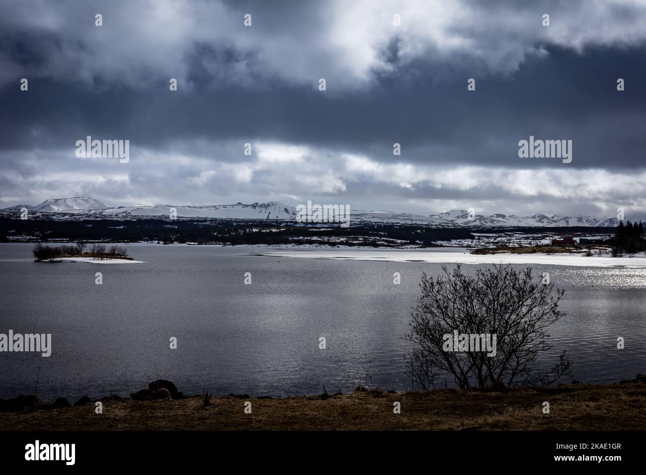 A lake in suburbs of Reykjavik, Iceland. Snowy mountain range in ...