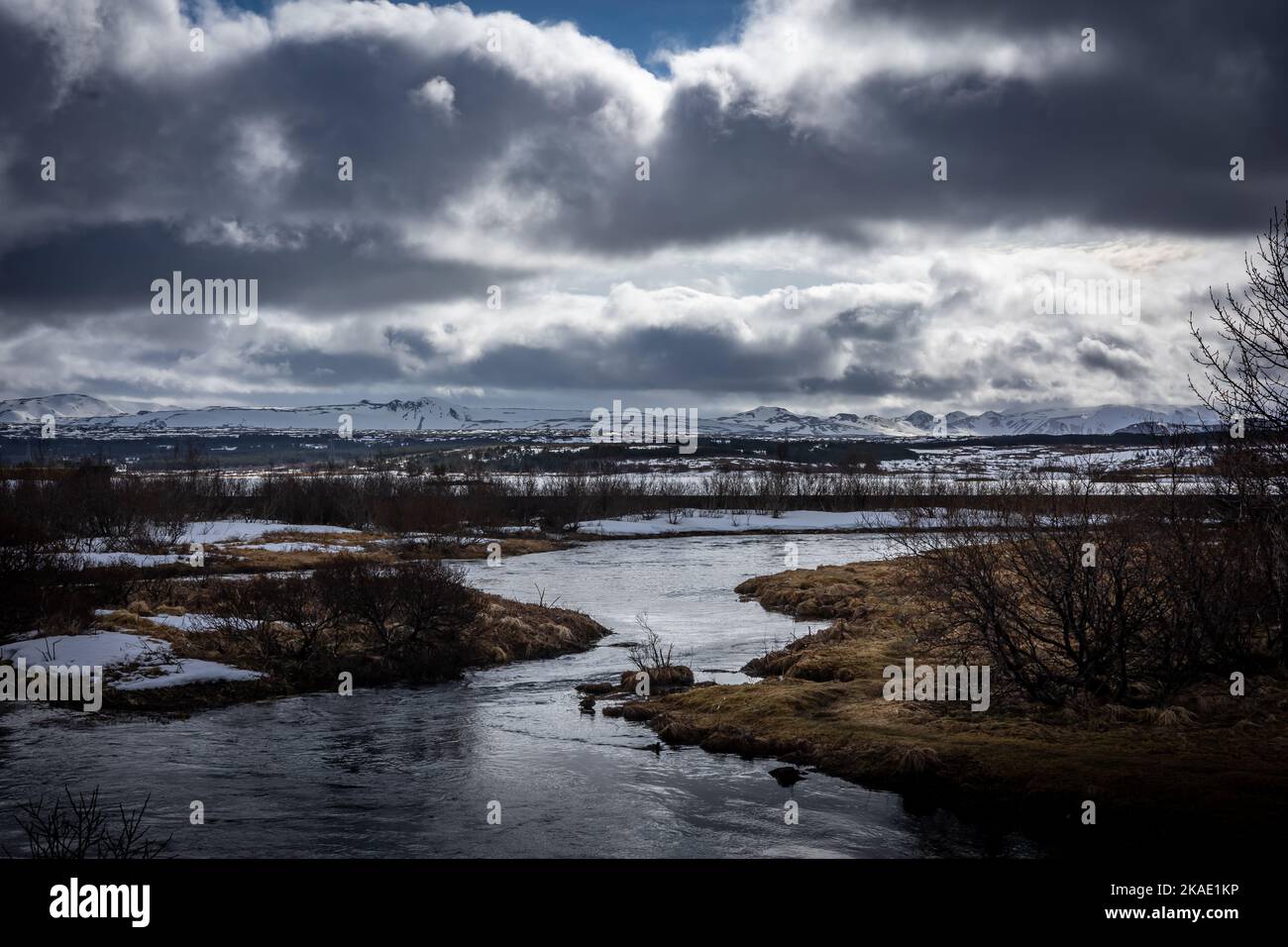A lake in suburbs of Reykjavik, Iceland. Snowy mountain range in ...