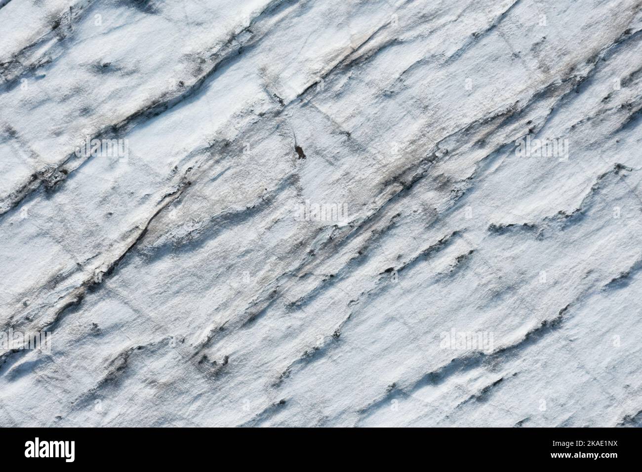 top view on white surface structures of arctic glacier in svalbard ...
