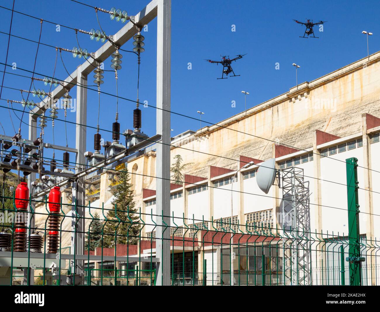 Drones flying over hydro electric dam. Concept image: military attack ...