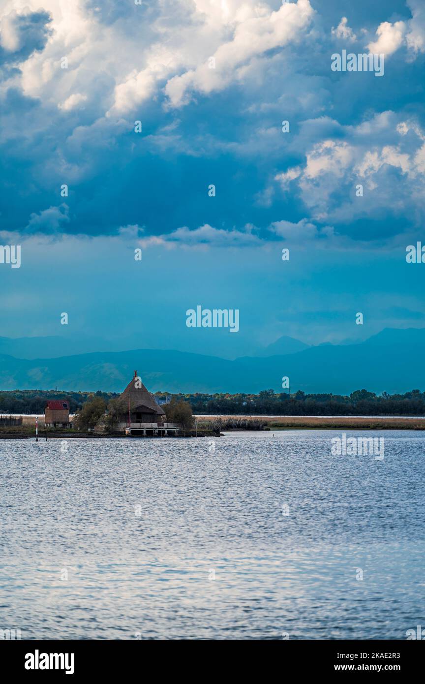 Towards the sunset. Marano lagoon late summer colors. Clouds and sun ...