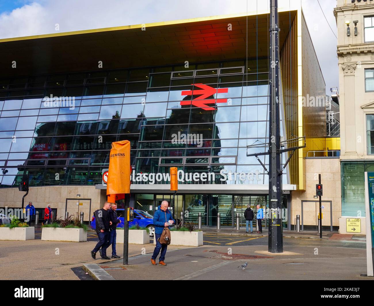 People walking past the exterior of Glasgow Queen Street train station ...