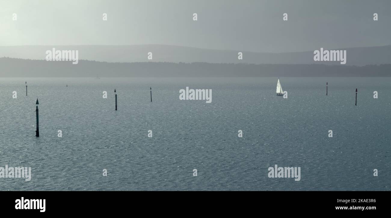 Yacht Lit By The Sun Sailing In The Solent With Lymington Harbour ...