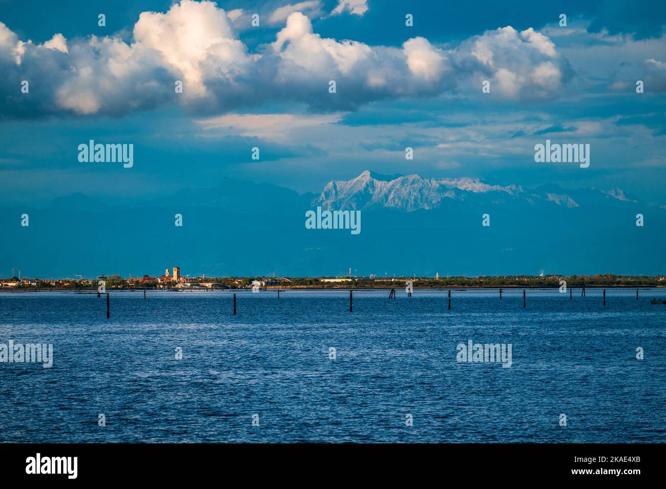Towards the sunset. Marano lagoon late summer colors. Clouds and sun ...