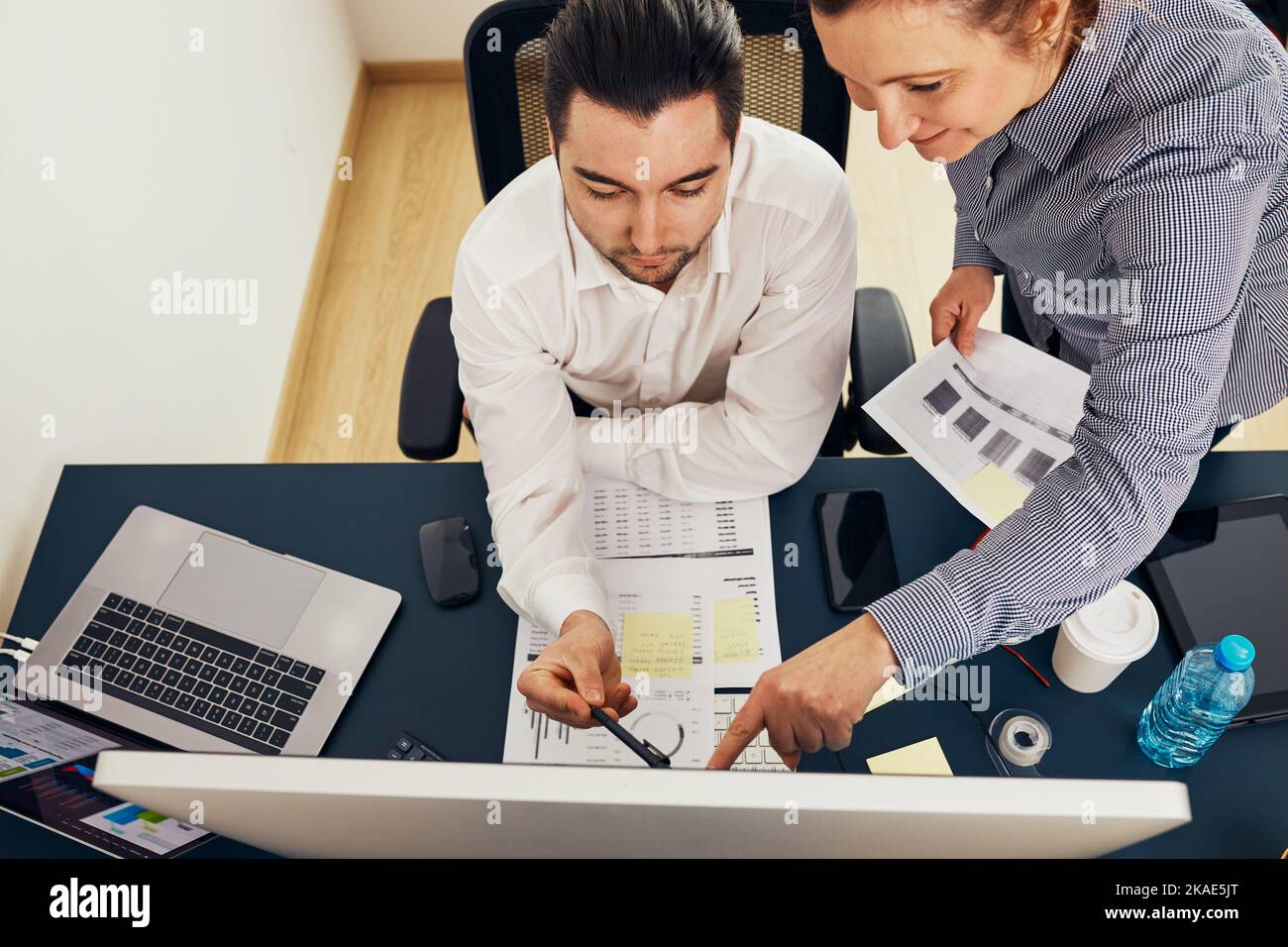 Business colleagues discussing financial data working together in ...