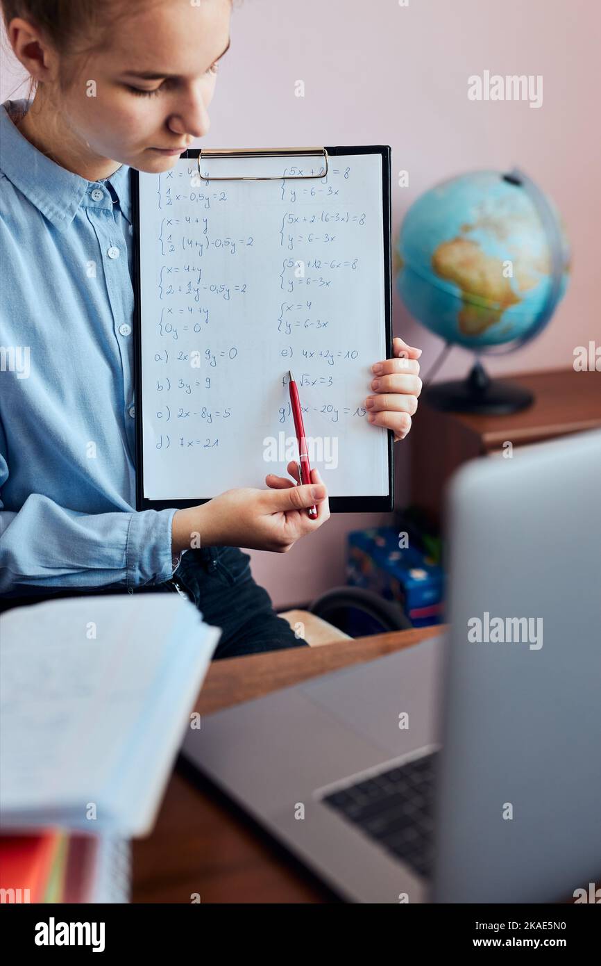 Young woman student showing homework, having classes, learning online ...