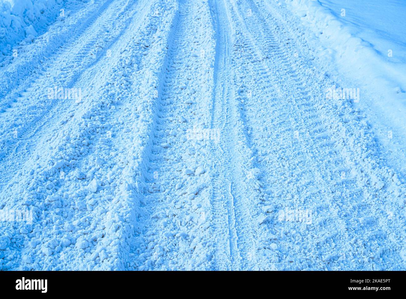 Texture of a snowy road with traces of car tires. Winter driving ...