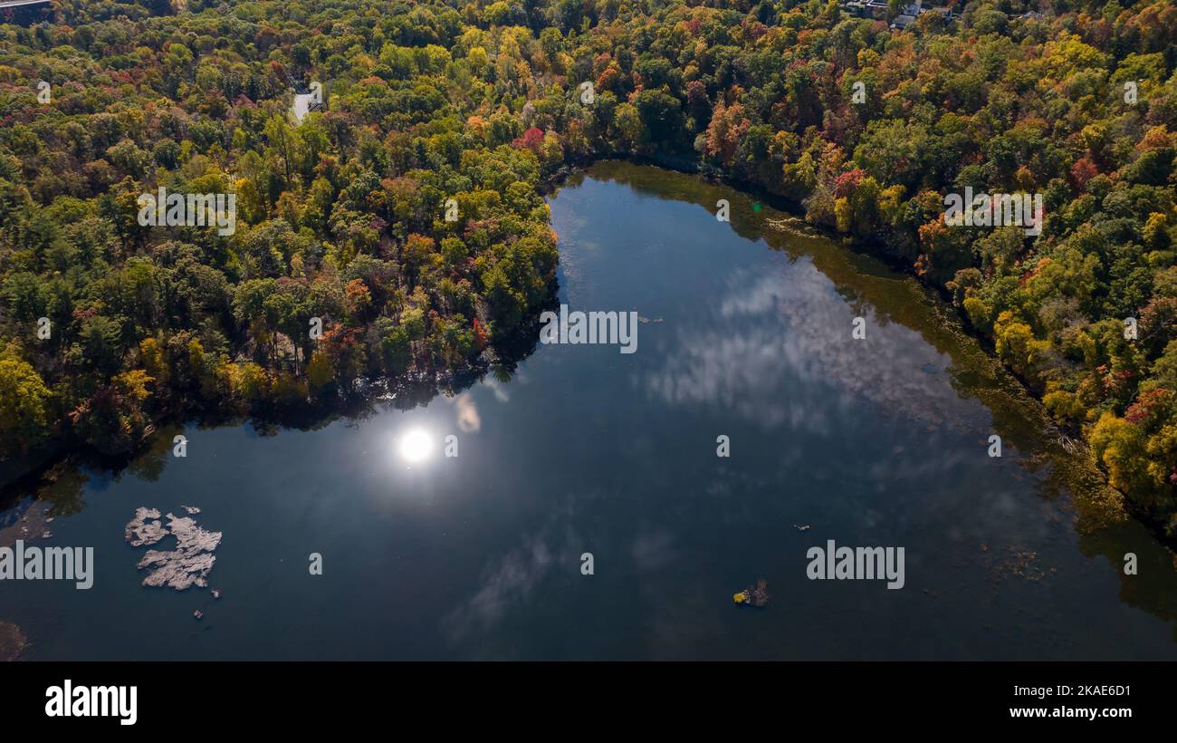 An aerial of a lake in upstate New York during the colorful fall ...