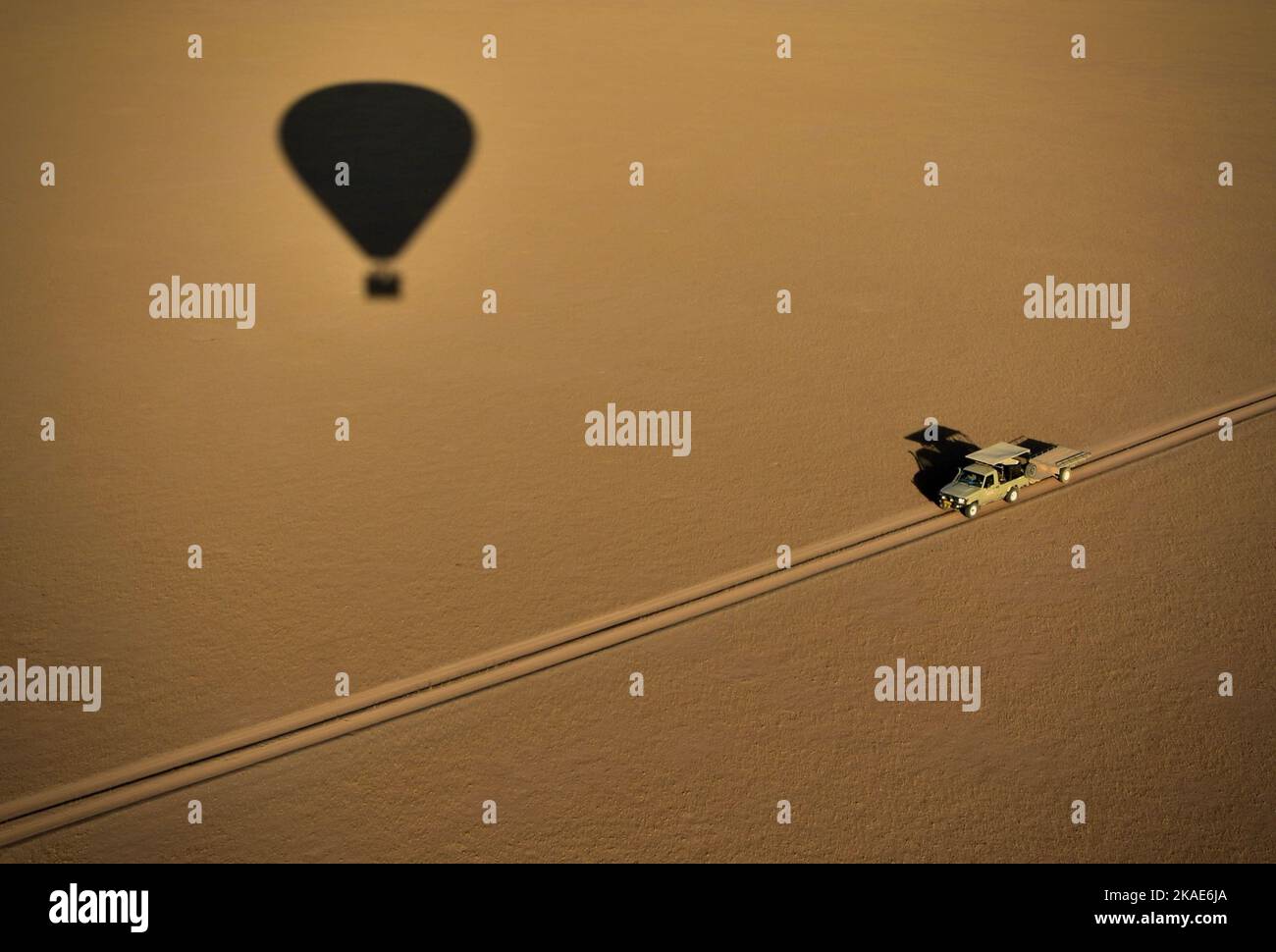 An aerial view of a Hot Air Balloon shadow on a desert road Stock Photo ...