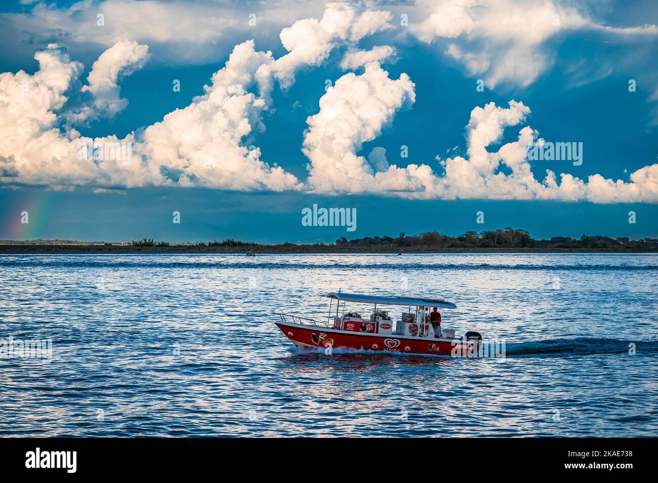 Towards the sunset. Marano lagoon late summer colors. Clouds and sun ...