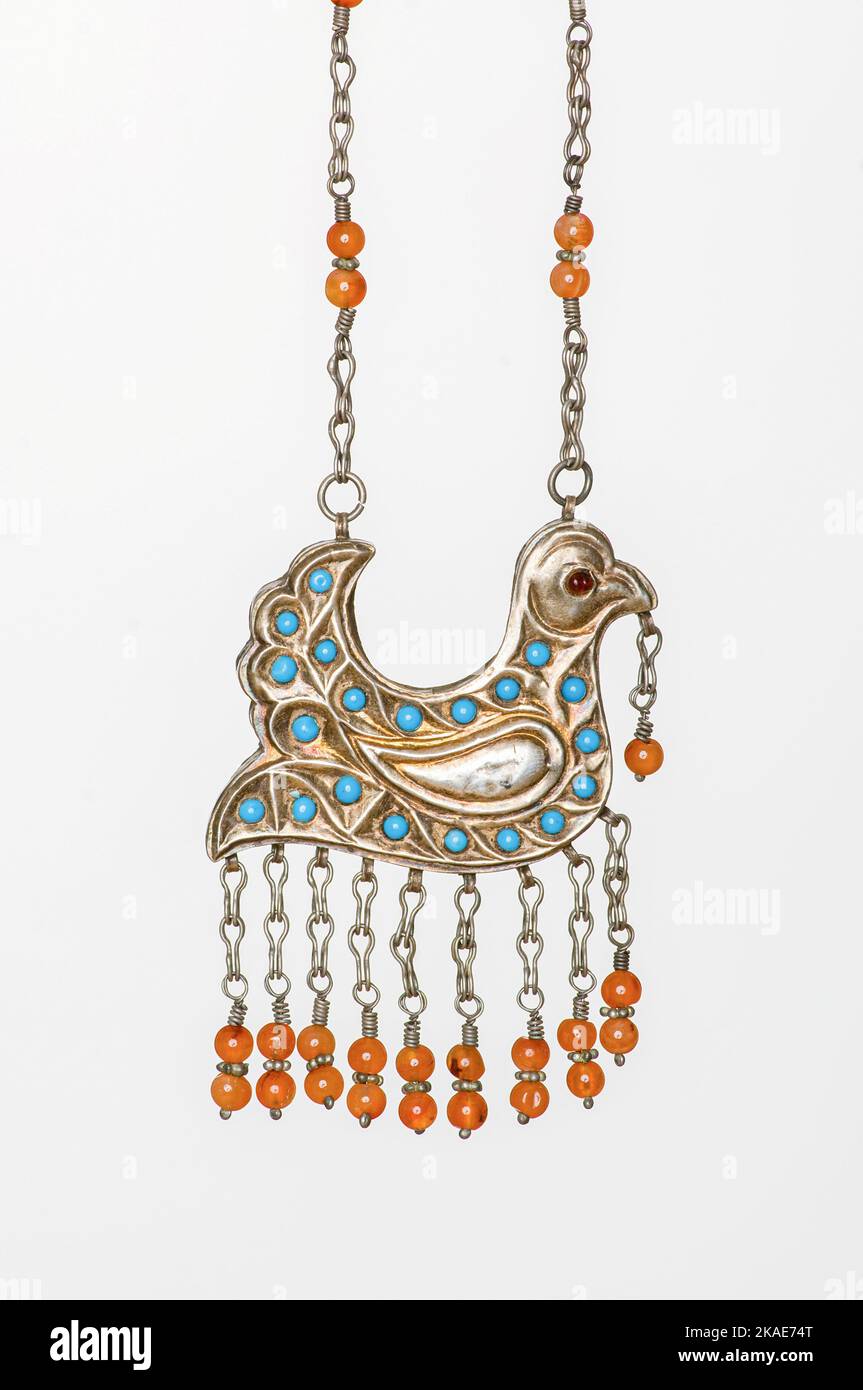 A Vintage, bird-shaped pendant with precious stones isolated on the ...