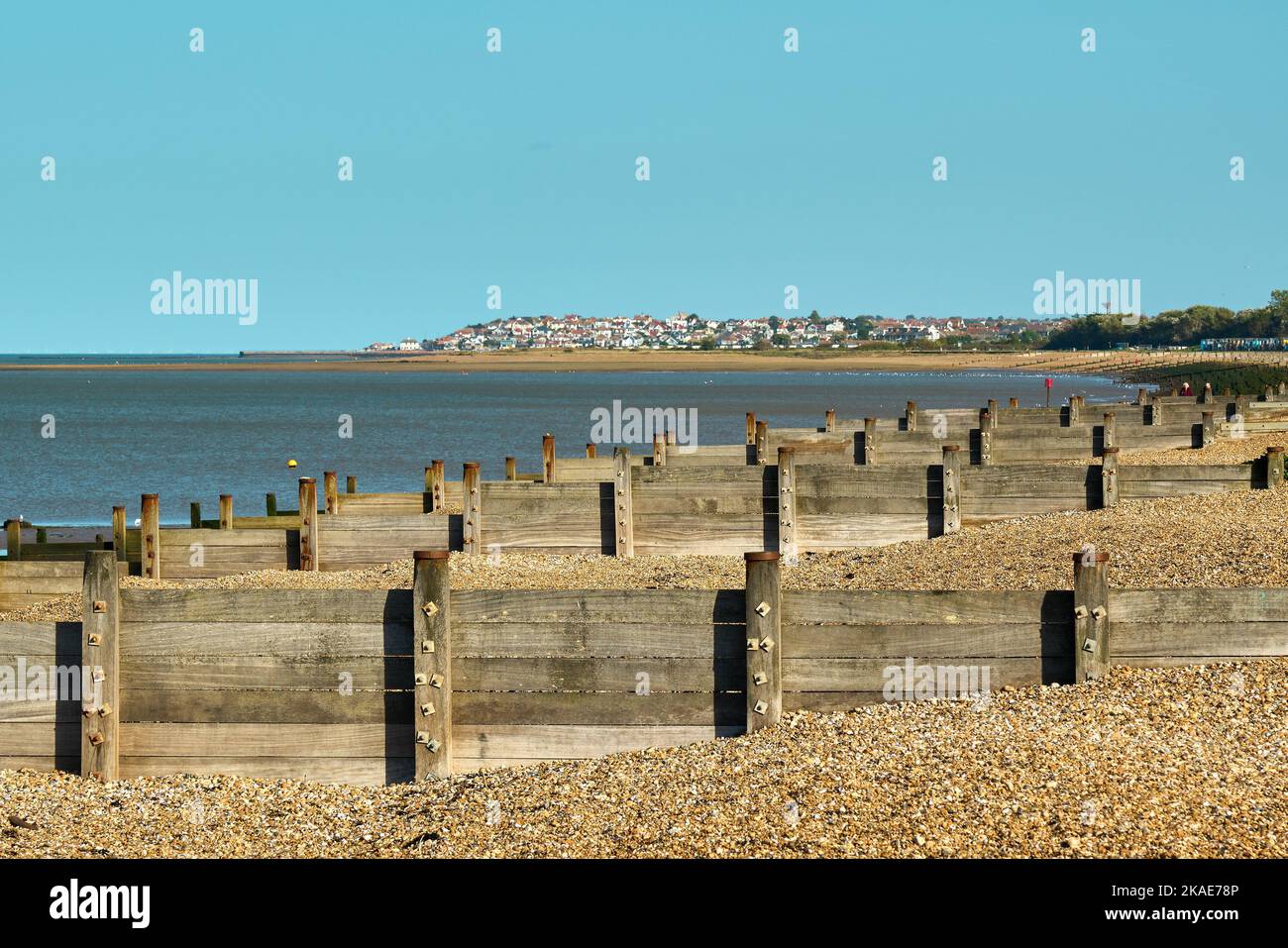 The groynes on the beach with Herne Bay in Thanet, Kent in the ...